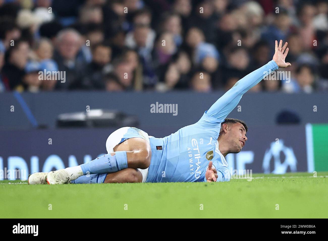 Matheus Nunes of Manchester City calls for a physio after picking up an ...