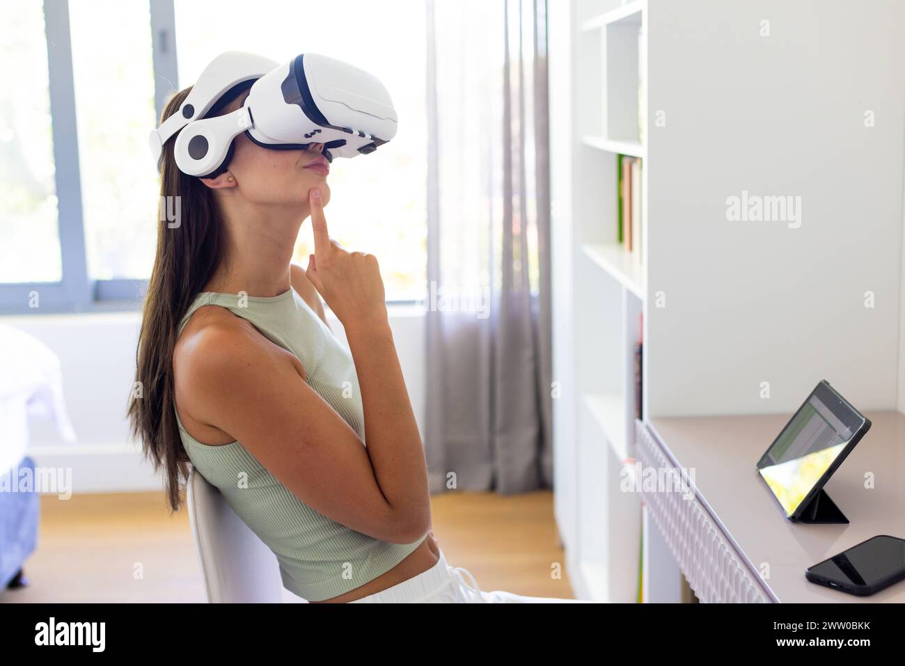 Woman is immersed in a virtual reality experience hi-res stock ...