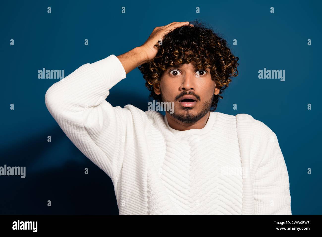 Portrait of young guy saying oops hand touch head puzzled do not ...