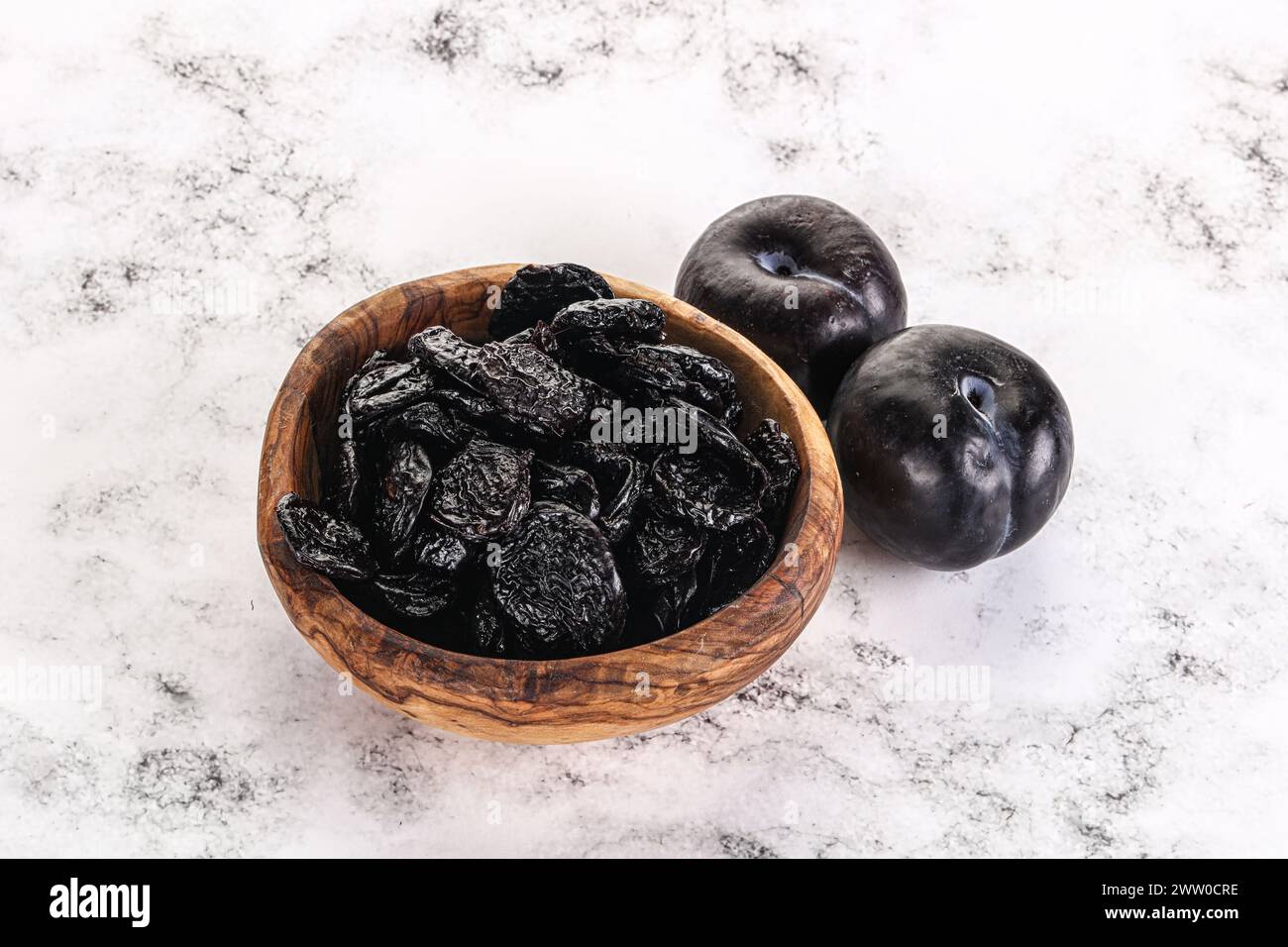 Dry sweet prunes in thw bowl Stock Photo - Alamy