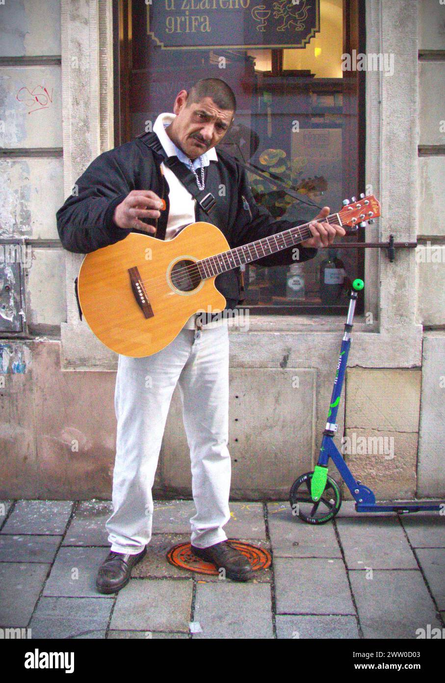 Street musician - a guy playing guitar in the street Stock Photo - Alamy
