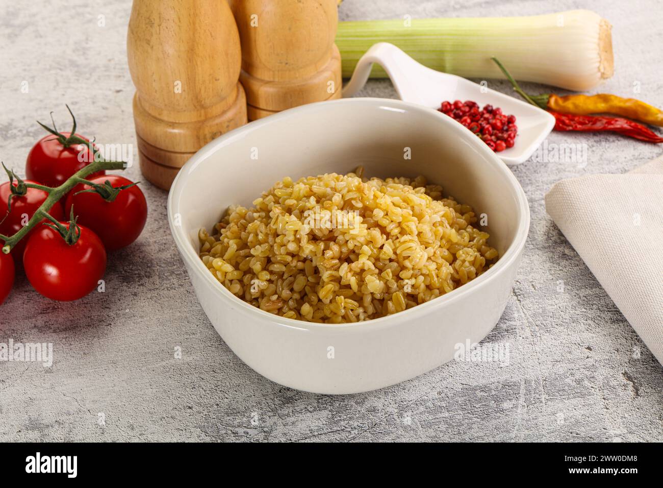 Boiled bulgur wheat in the bowl garnish Stock Photo - Alamy