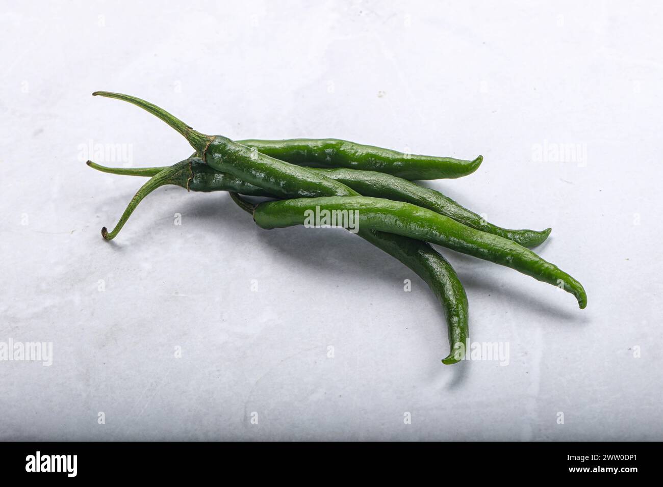 Hot and spicy green chili pepper heap Stock Photo - Alamy