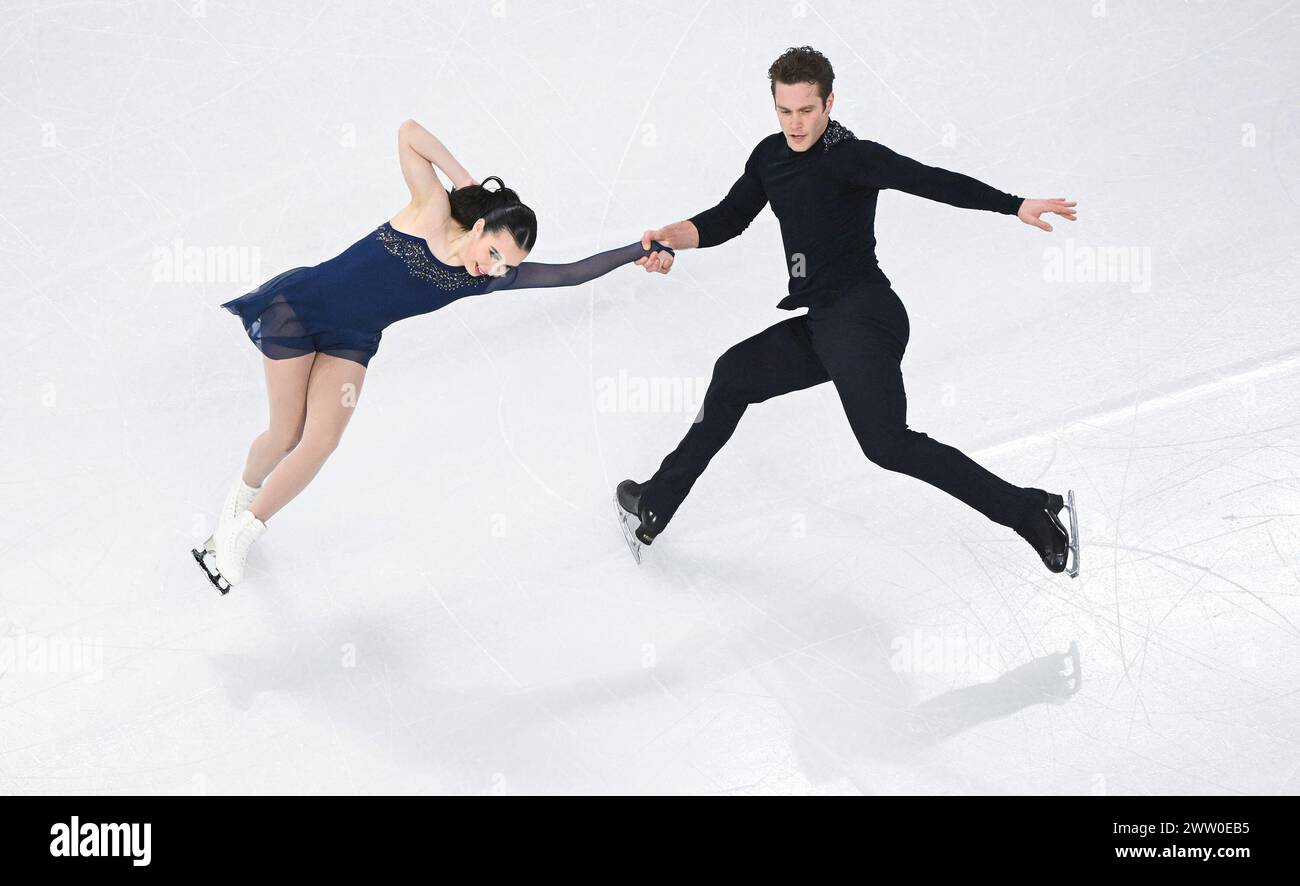 Lia Pereira and Trennt Michaud, of Canada, perform their pairs short ...