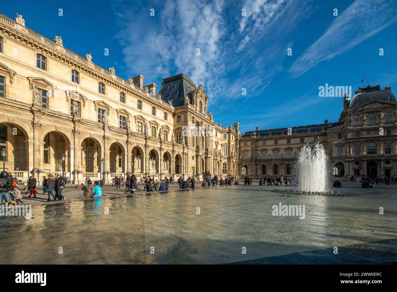 Visitors walking near the Palais Royal under a clear blue sky Stock ...