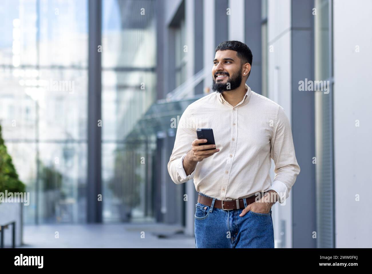 Young man engaged smartphone standing hi-res stock photography and ...