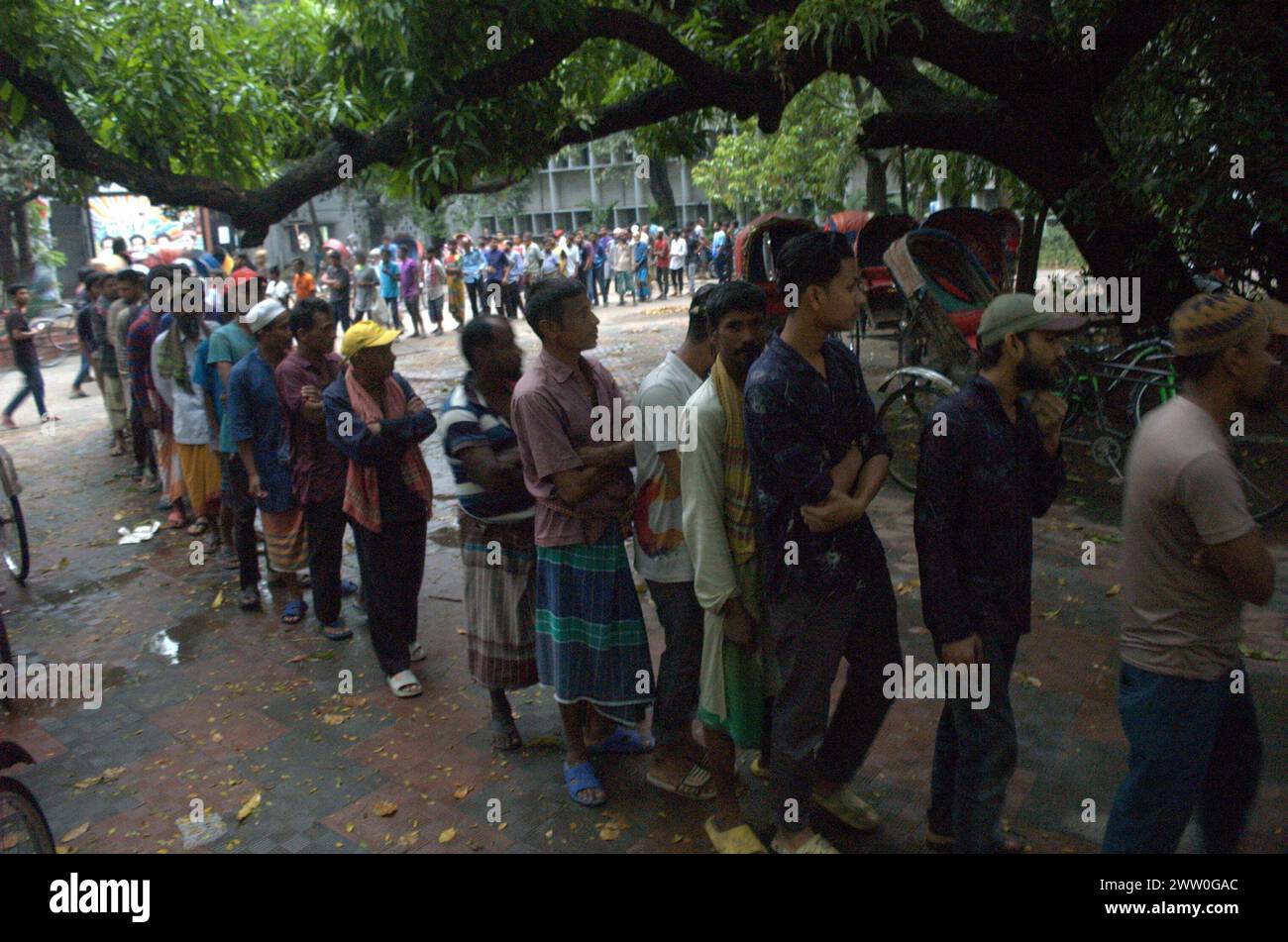 Dhaka, Bangladesh. 21st Mar, 2024. People queue to collect free food to break their fast during ...