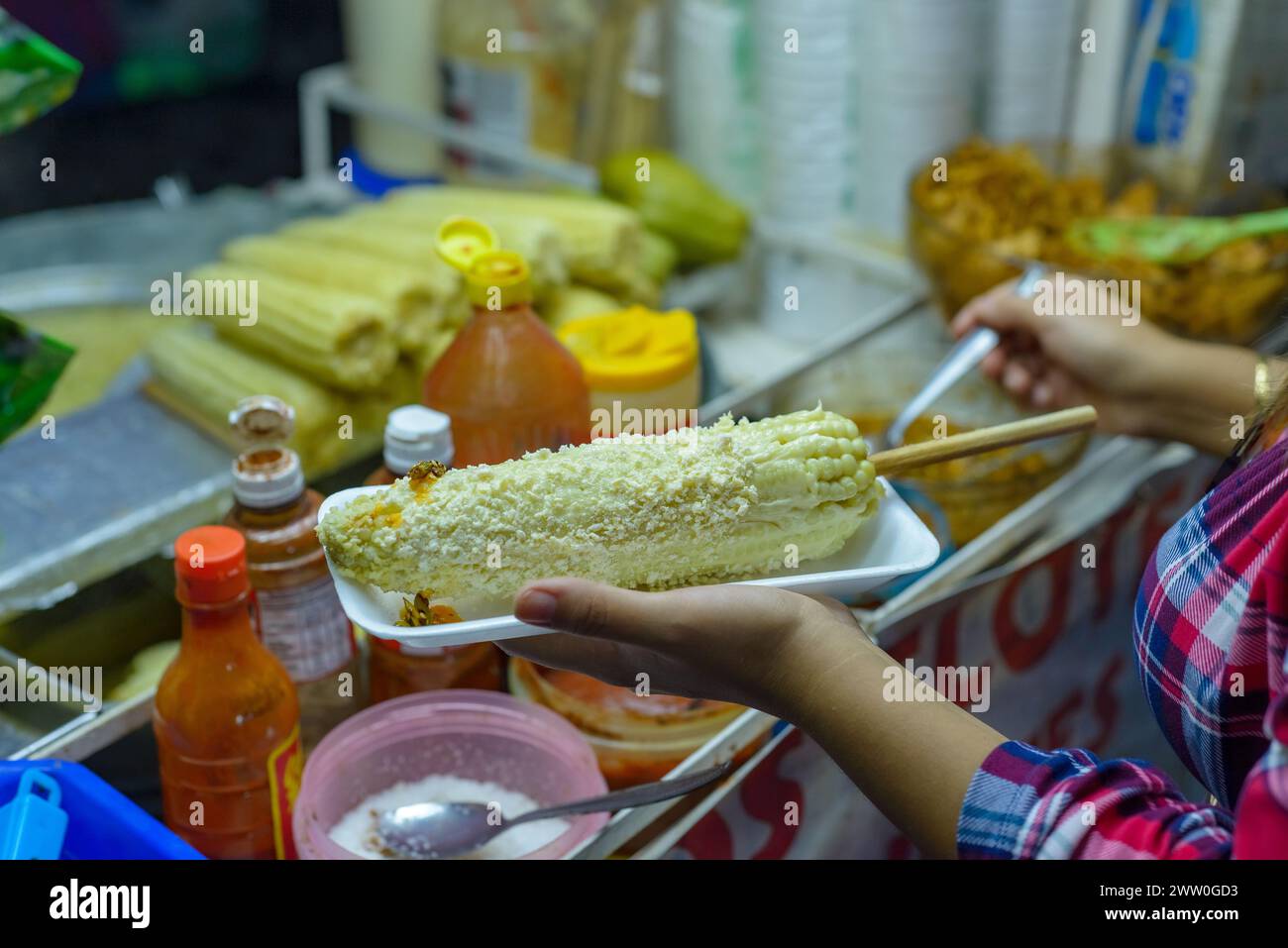 Mexican woman preparing a boiled corn, typical Mexican street food ...