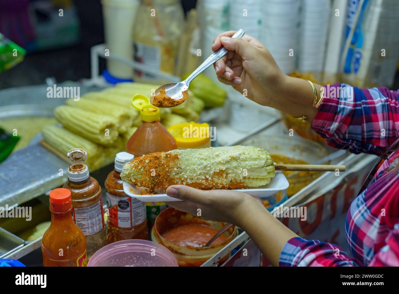 Mexican woman preparing a boiled corn, typical Mexican street food ...