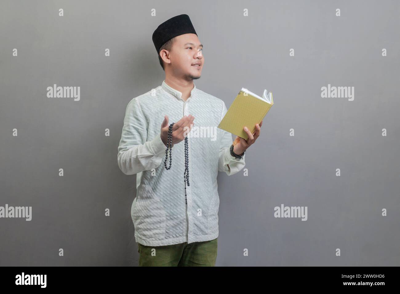 Asian Muslim man wearing a koko shirt and peci with shades of the ...
