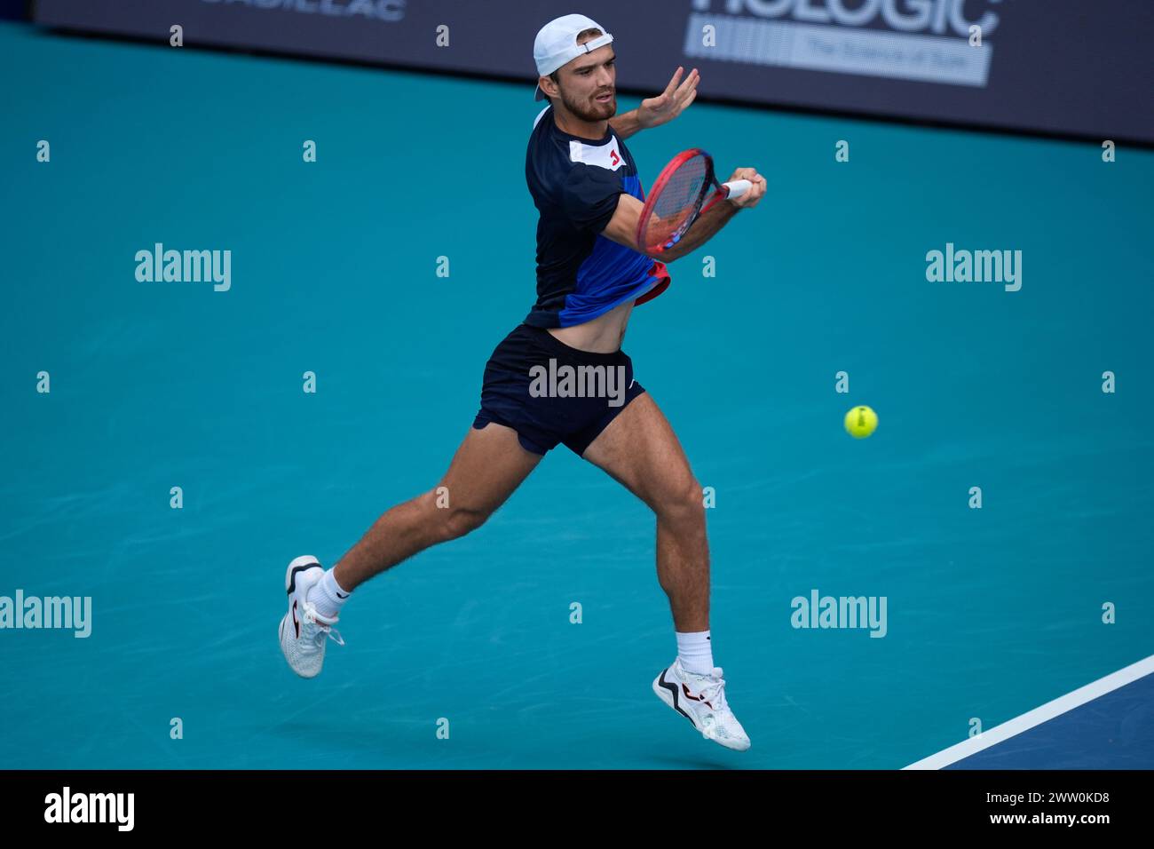 Tomas Machac, of Czech Republic, returns a ball in his first round ...