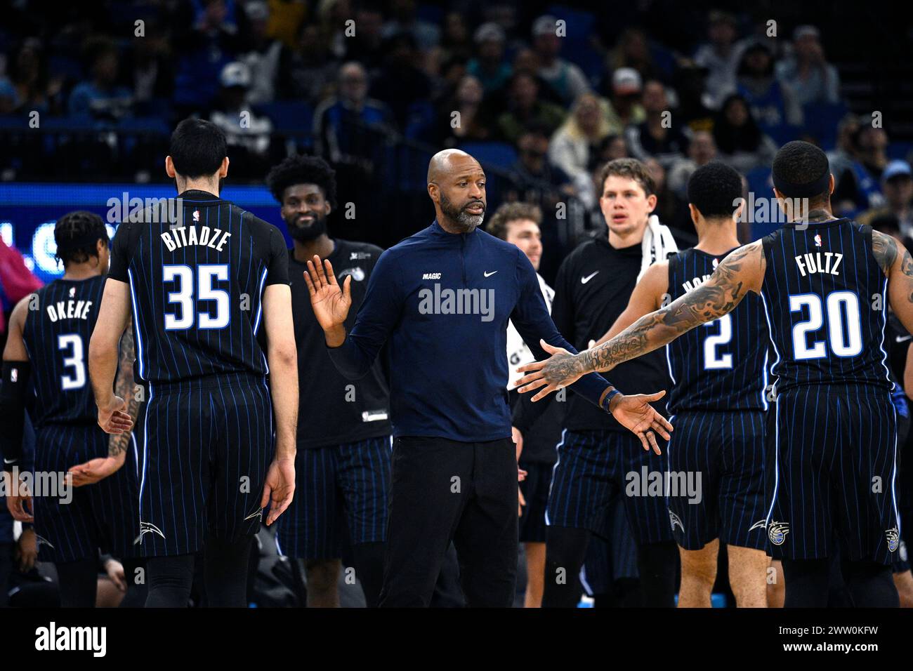 Orlando Magic head coach Jamahl Mosley, center, greets players coming ...