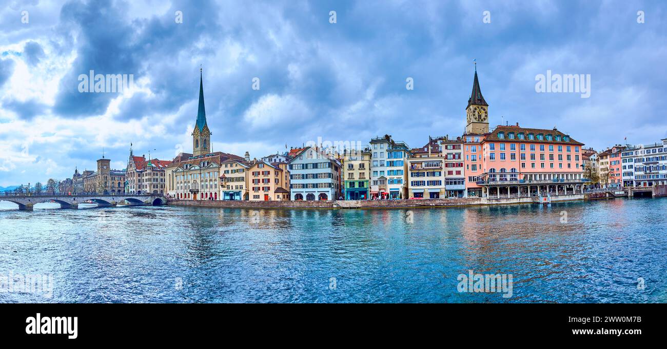 Panorama of the riverside housing of Limmat river with bell towers of ...