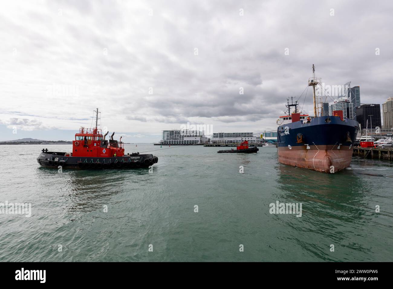 Two tug boats assist the Cargo ship Rangitata to get off the dock at ...