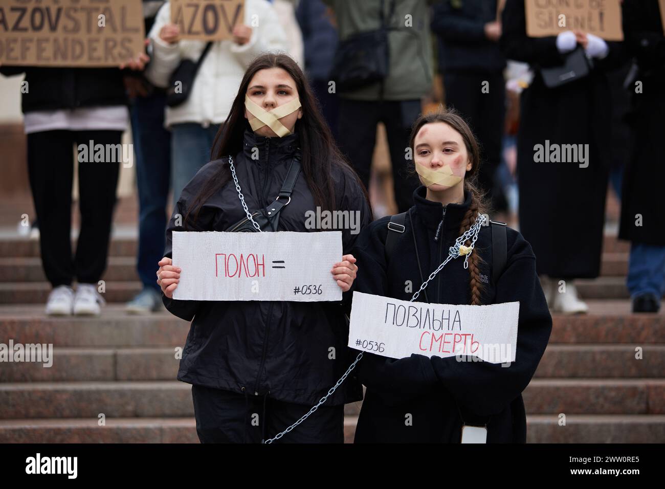 Young Ukrainian girls with sewn up mouth posing with banners "Captivity ...