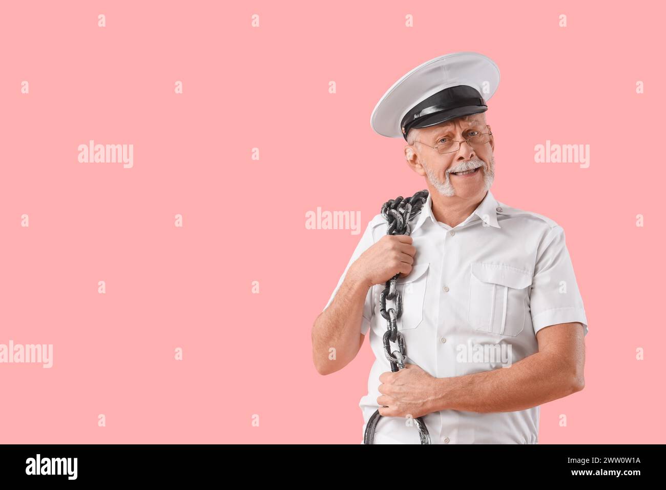 Mature sailor with chain on pink background Stock Photo - Alamy