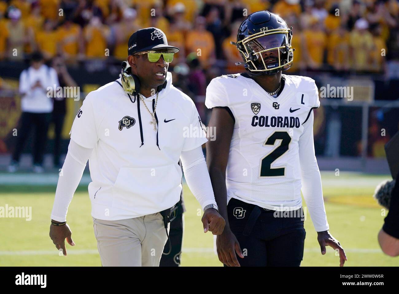 FILE - Colorado head coach Deion Sanders, left, talks with his son and ...