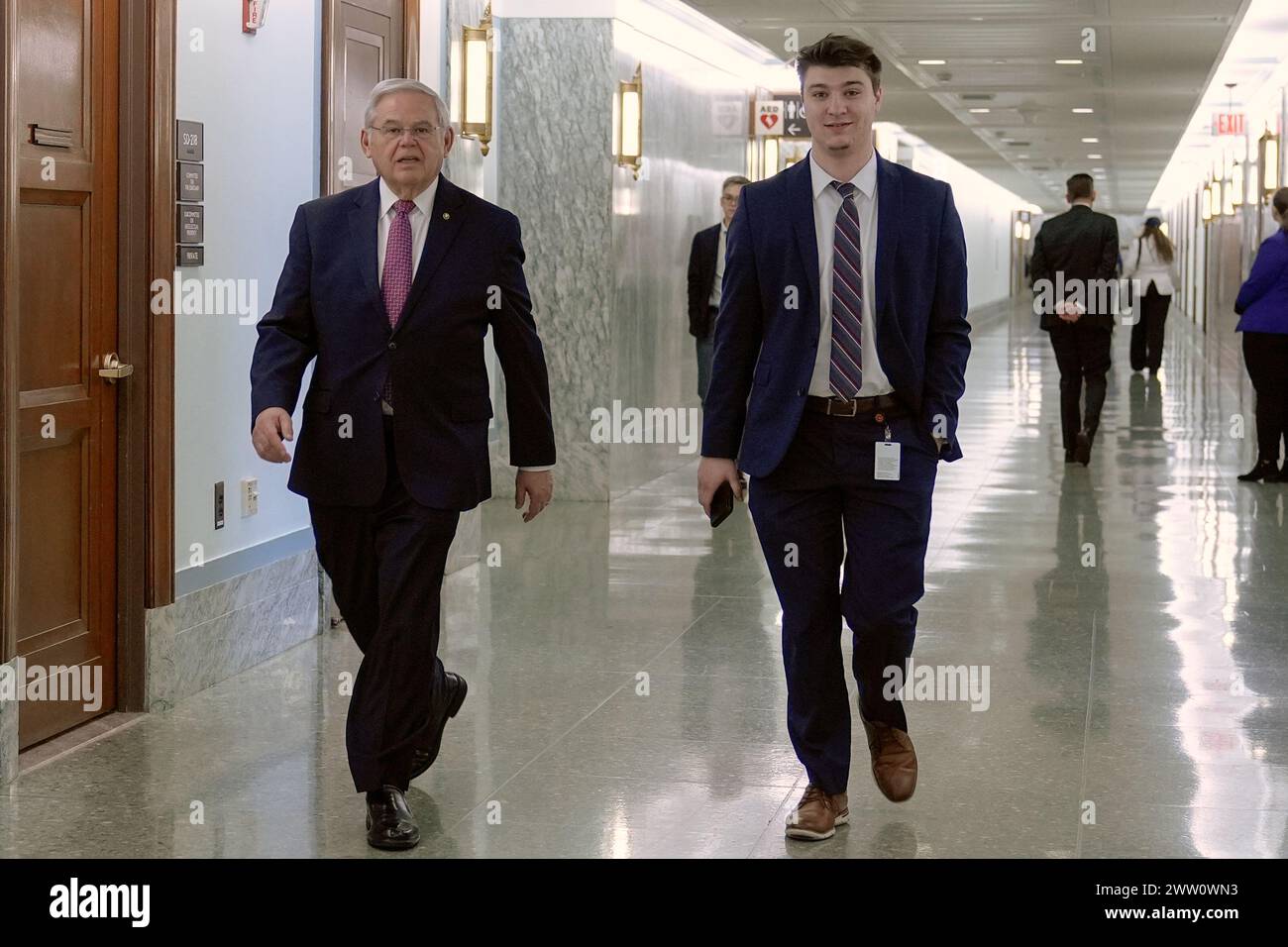 Sen. Bob Menendez, D-N.J., left, walks at the hallway of Dirksen Senate ...