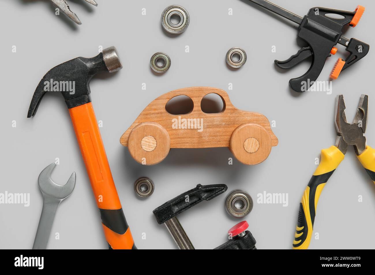 Set of mechanic instruments and toy car on white background, closeup ...