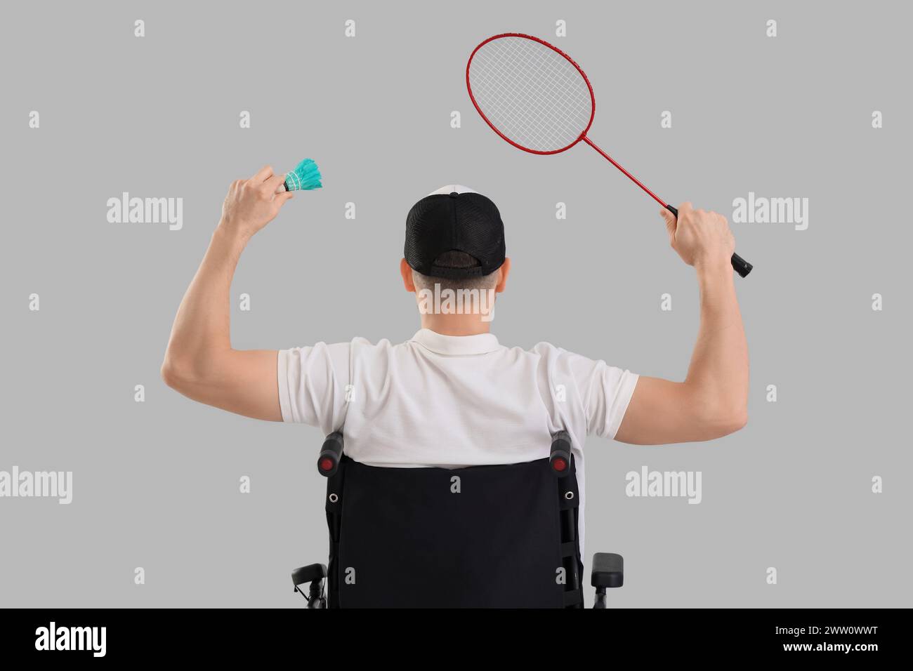Badminton player in wheelchair with racket and shuttlecock on light ...