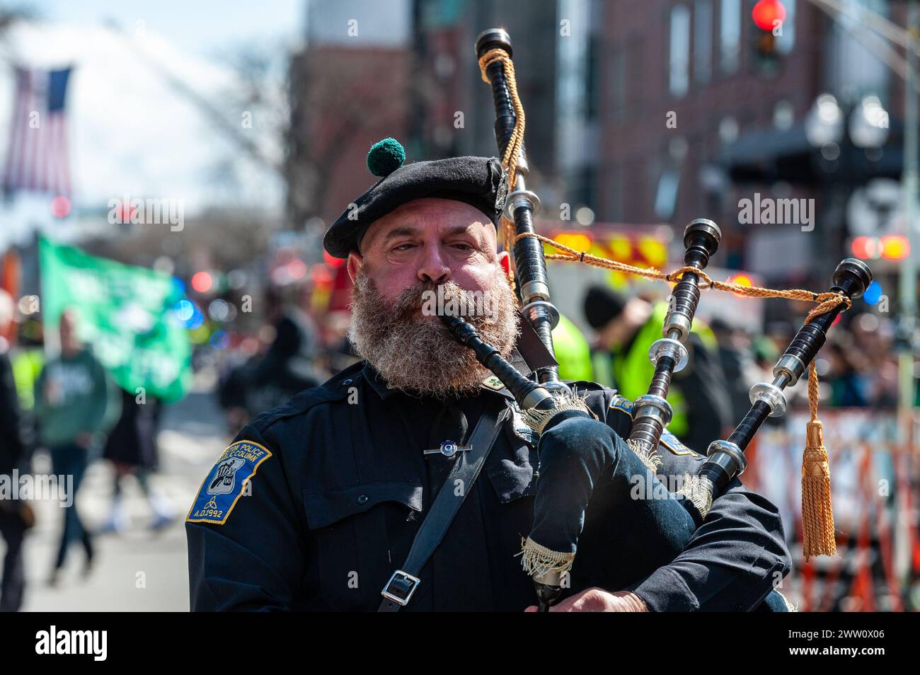 An officer with the Boston Police Gaelic Column of Pipes and Drums at ...