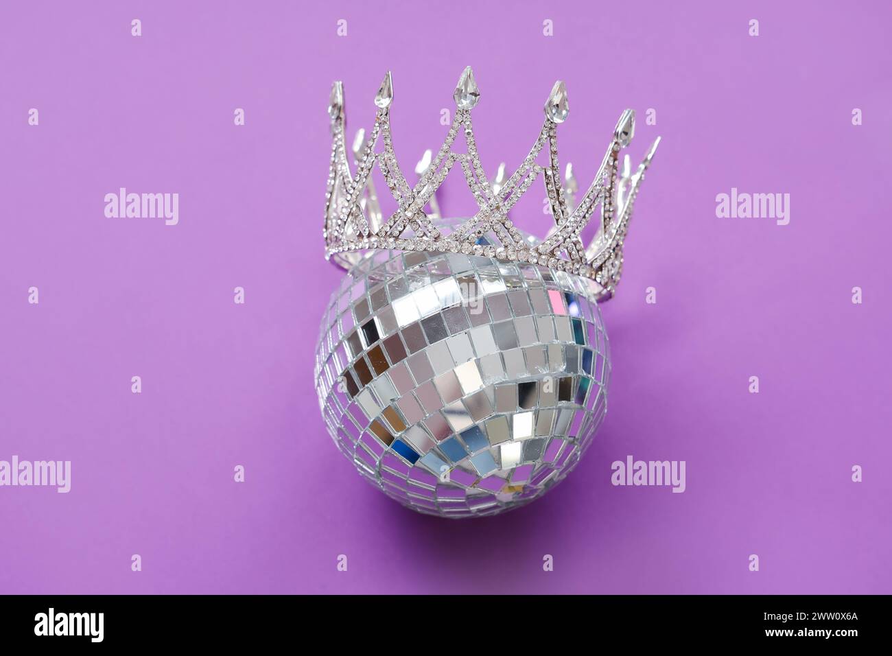 Disco ball with prom crown on purple background Stock Photo - Alamy