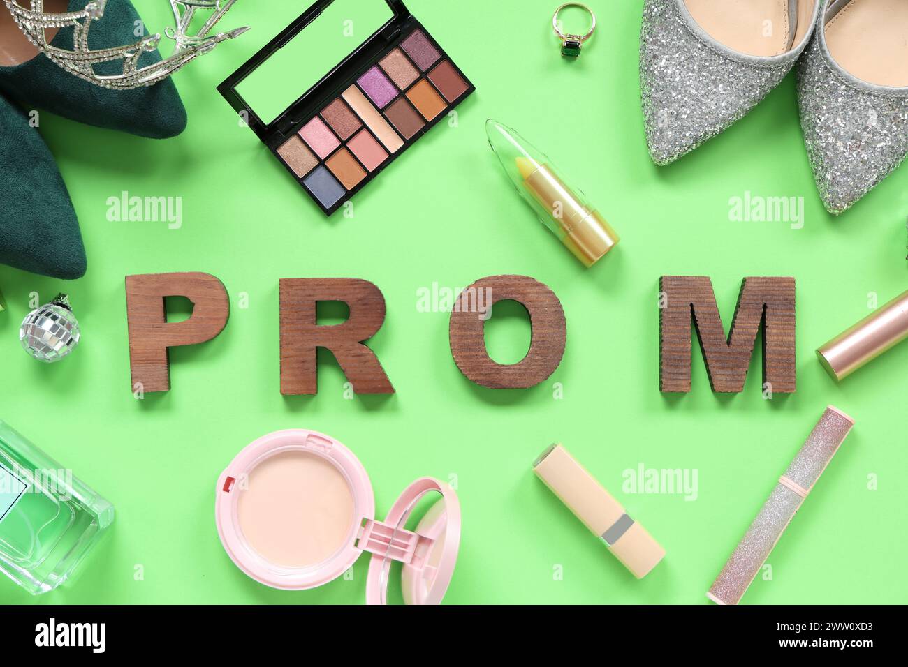 Word PROM with female shoes, crown and makeup products on green ...