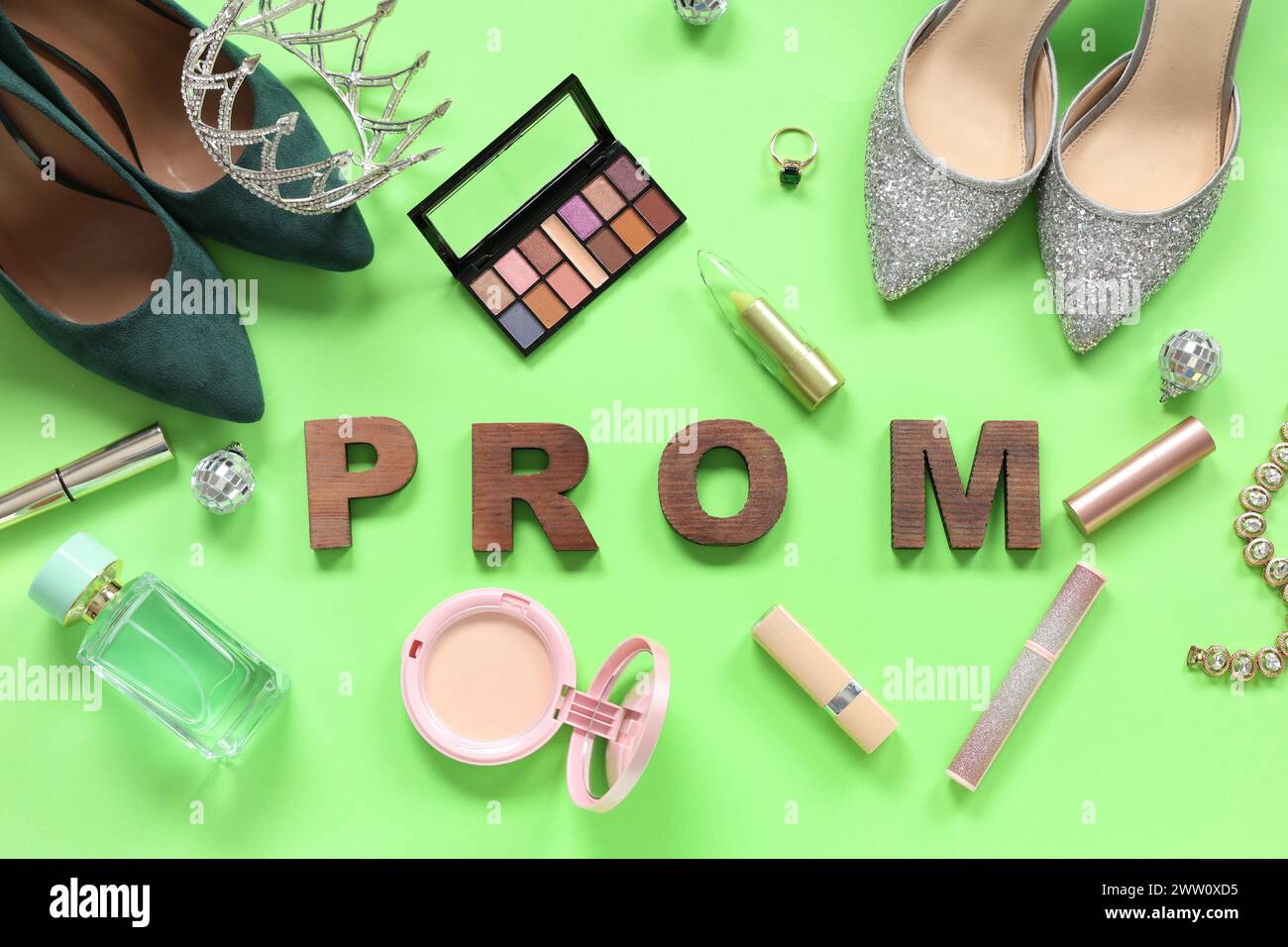 Word PROM with female shoes, crown and makeup products on green ...