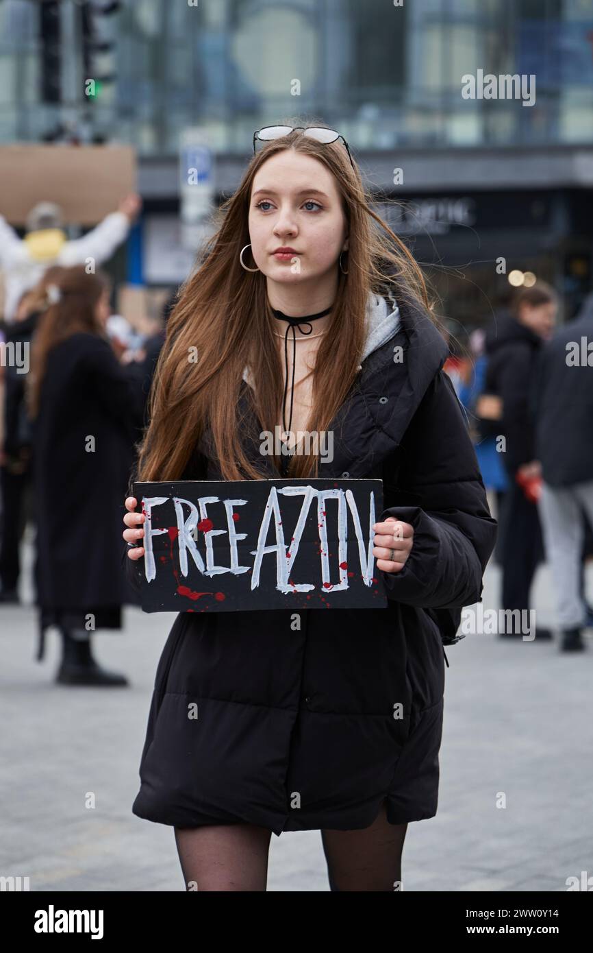 Young Ukrainian girl walks with a banner "Free Azov" on a peaceful ...