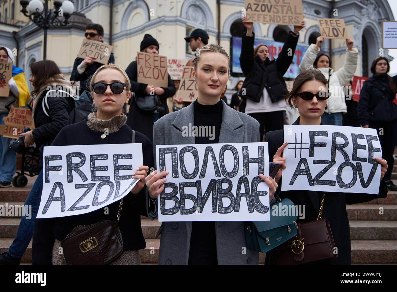 Young Ukrainian girls posing with banners "Free Azov" and "Captivity ...