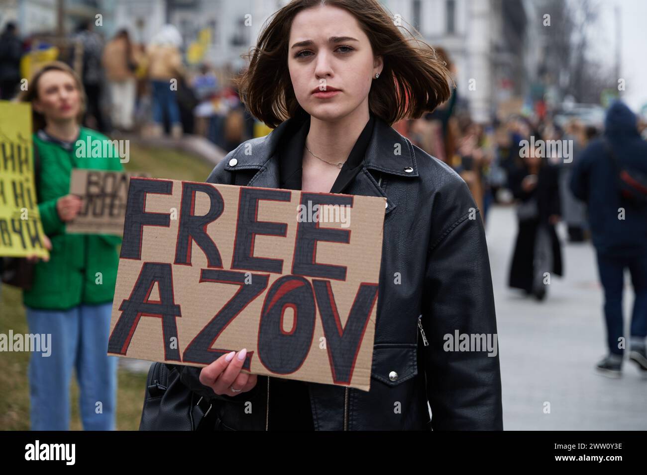 Ukrainian girl walks with a banner "Free Azov" on a public ...