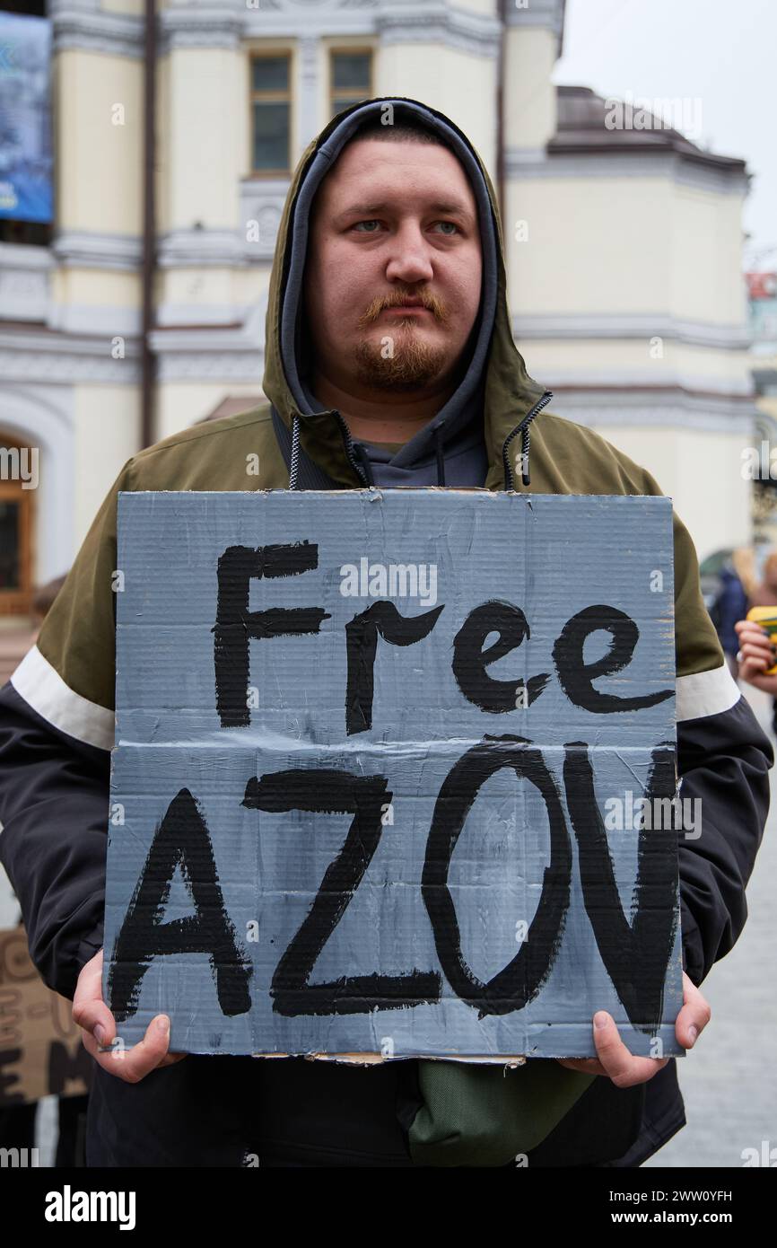 Ukrainian man posing with a banner "Free Azov" on a public action for ...