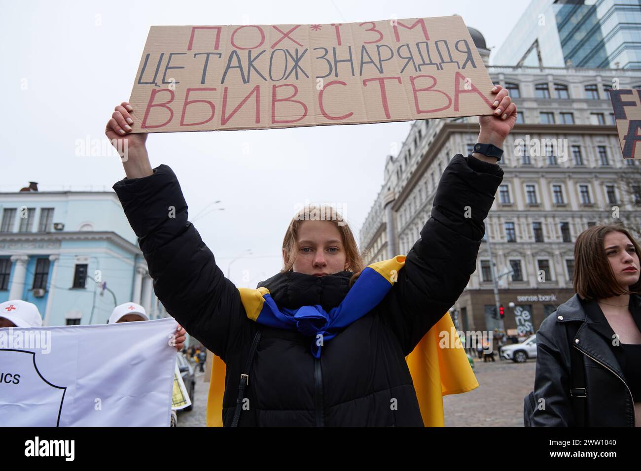 Ukrainian girl showing a banner "Free Azov" on a demonstration ...