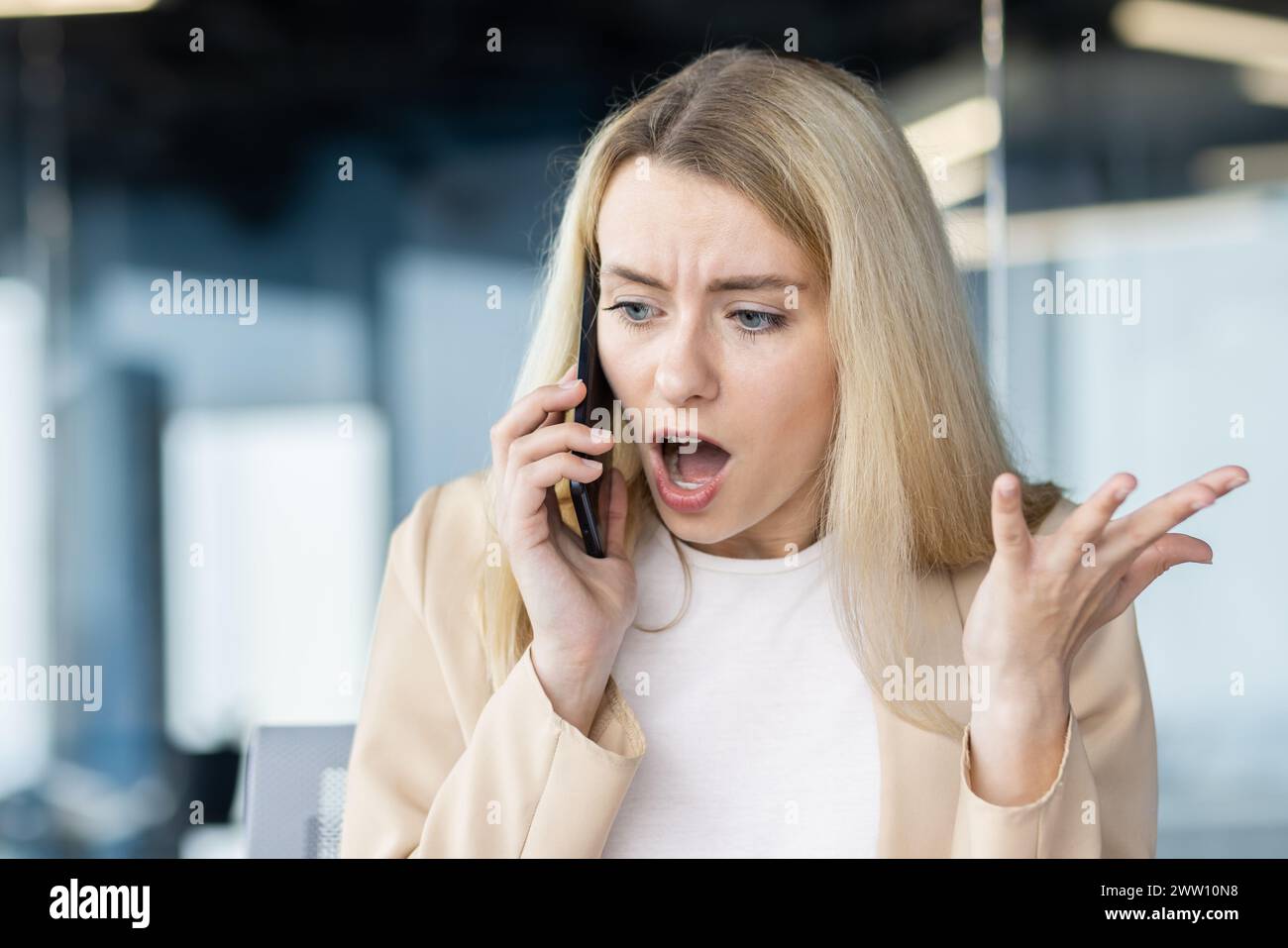 Worried female professional in conversation on mobile phone, expressing ...