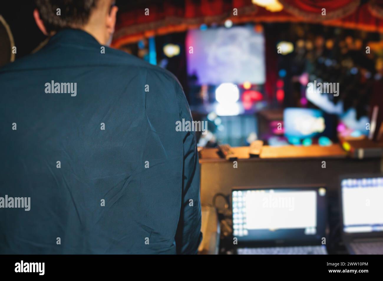View of lighting technician operator working on mixing console ...