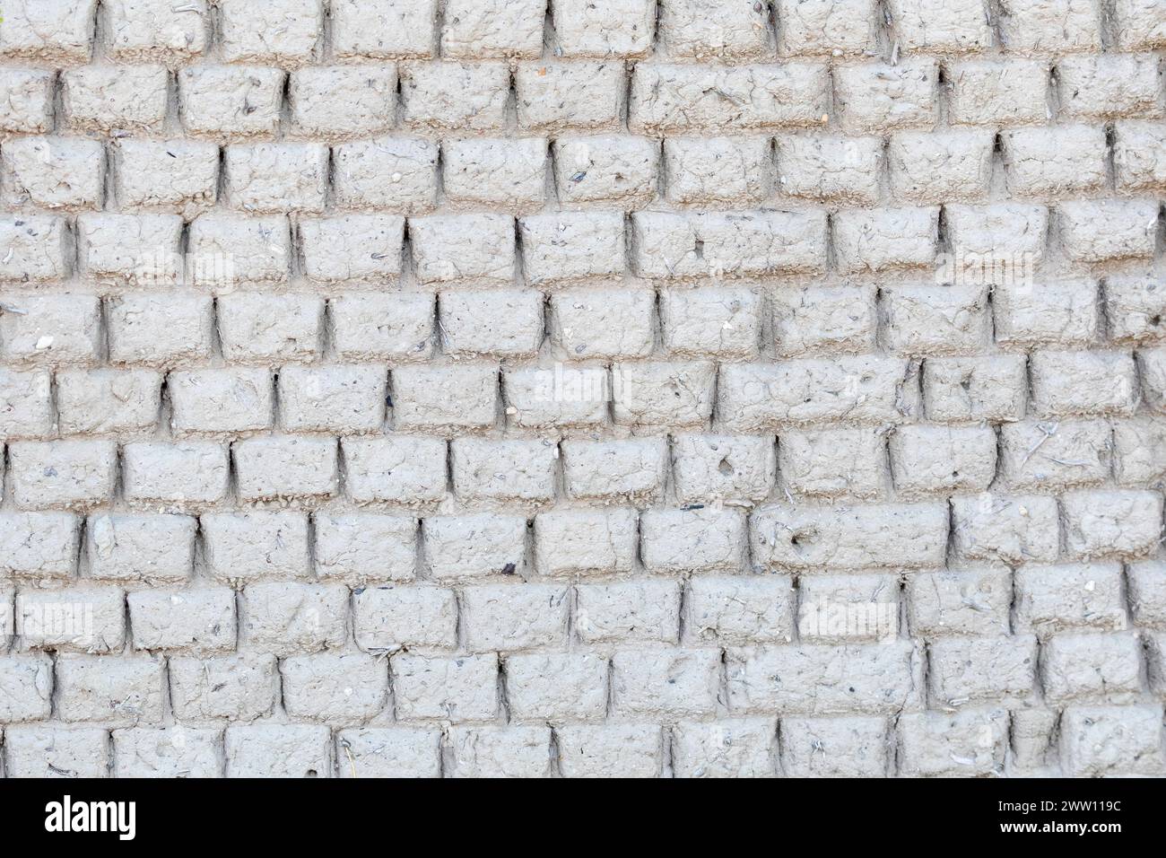 Handmade natural grey clay brick wall background texture with shell ...