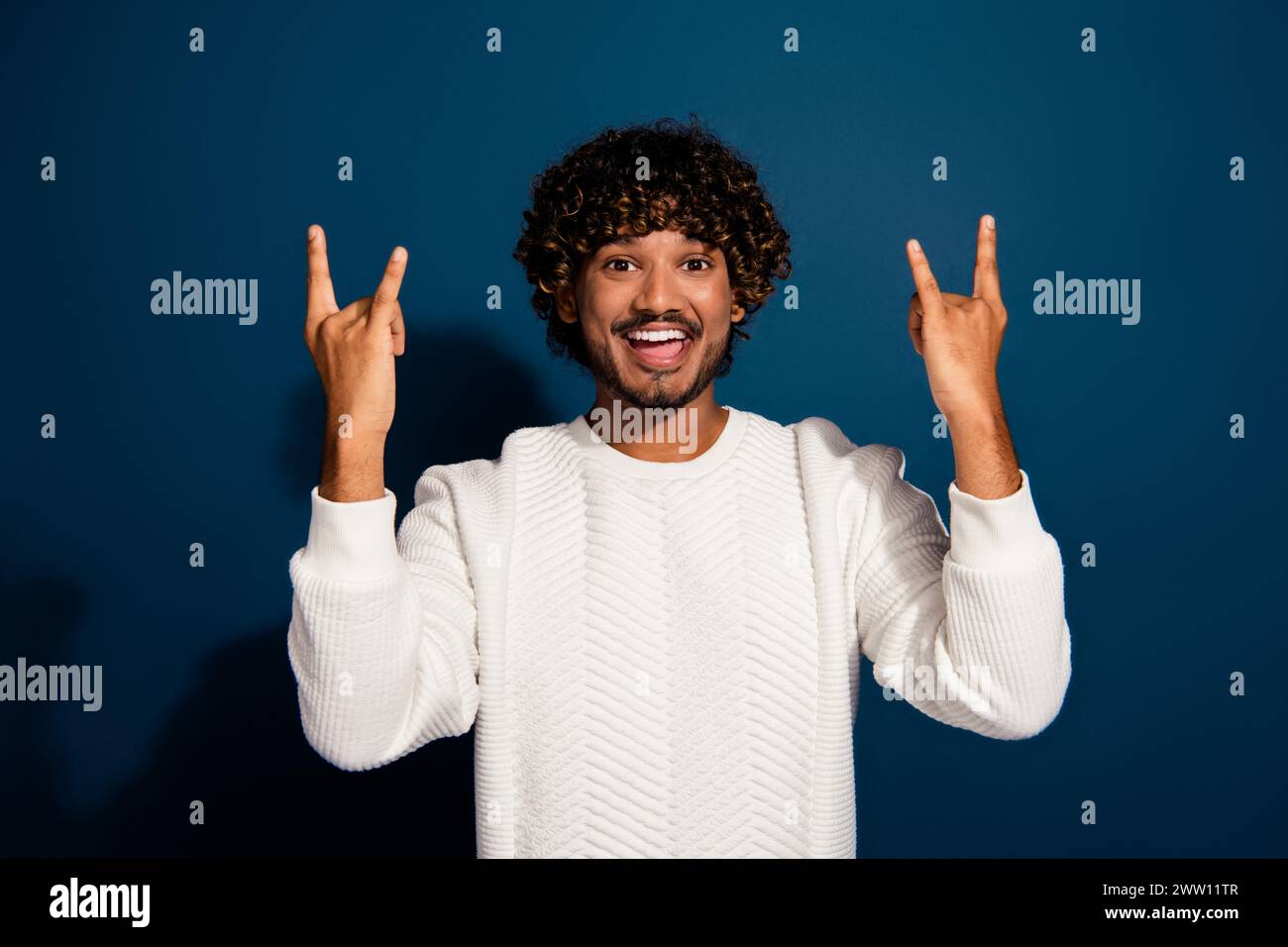 Photo of cheerful positive man wear white sweater smiling showing two ...