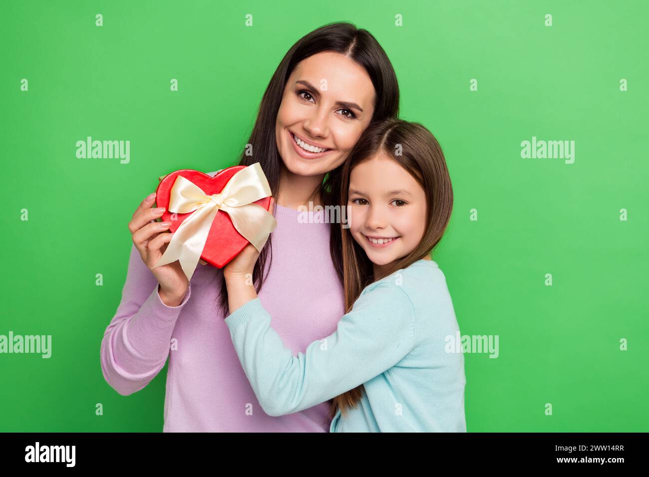 Portrait of two people mother daughter cuddle hold heart giftbox candy ...