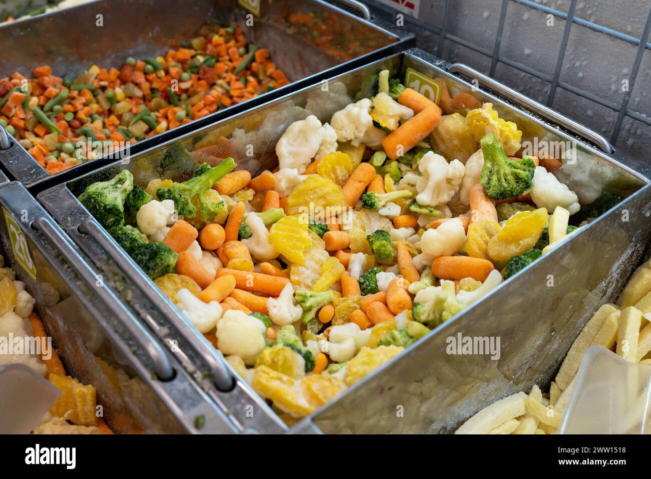Frozen vegetables. Selling frozen vegetables in the fridge of a grocery ...