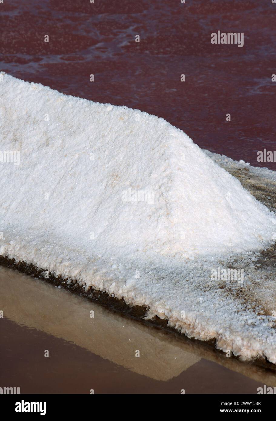 Portugal, Algarve. Harvested fleur de sel. Salt mound and reflection in ...