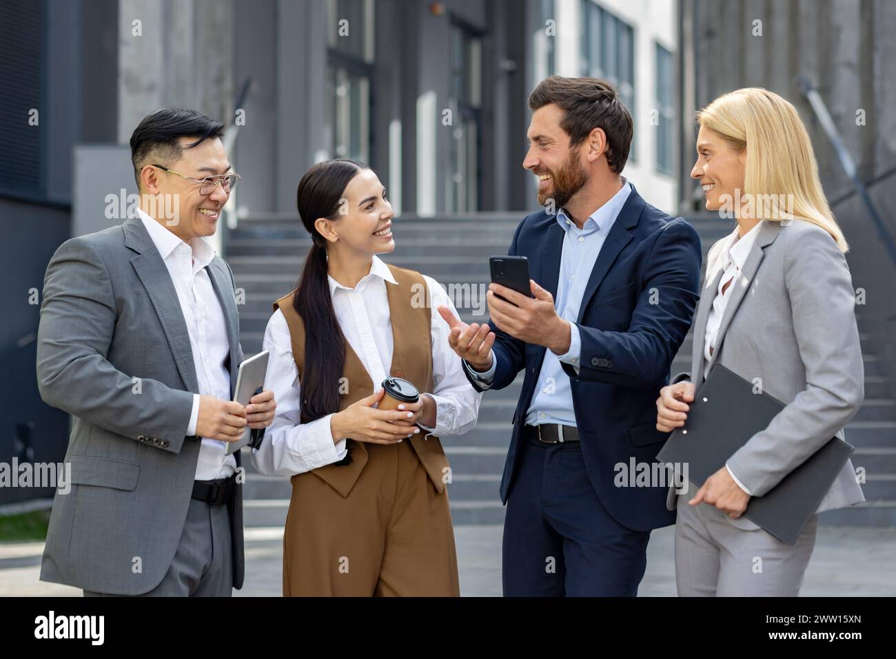 Four business colleagues having talk hi-res stock photography and ...