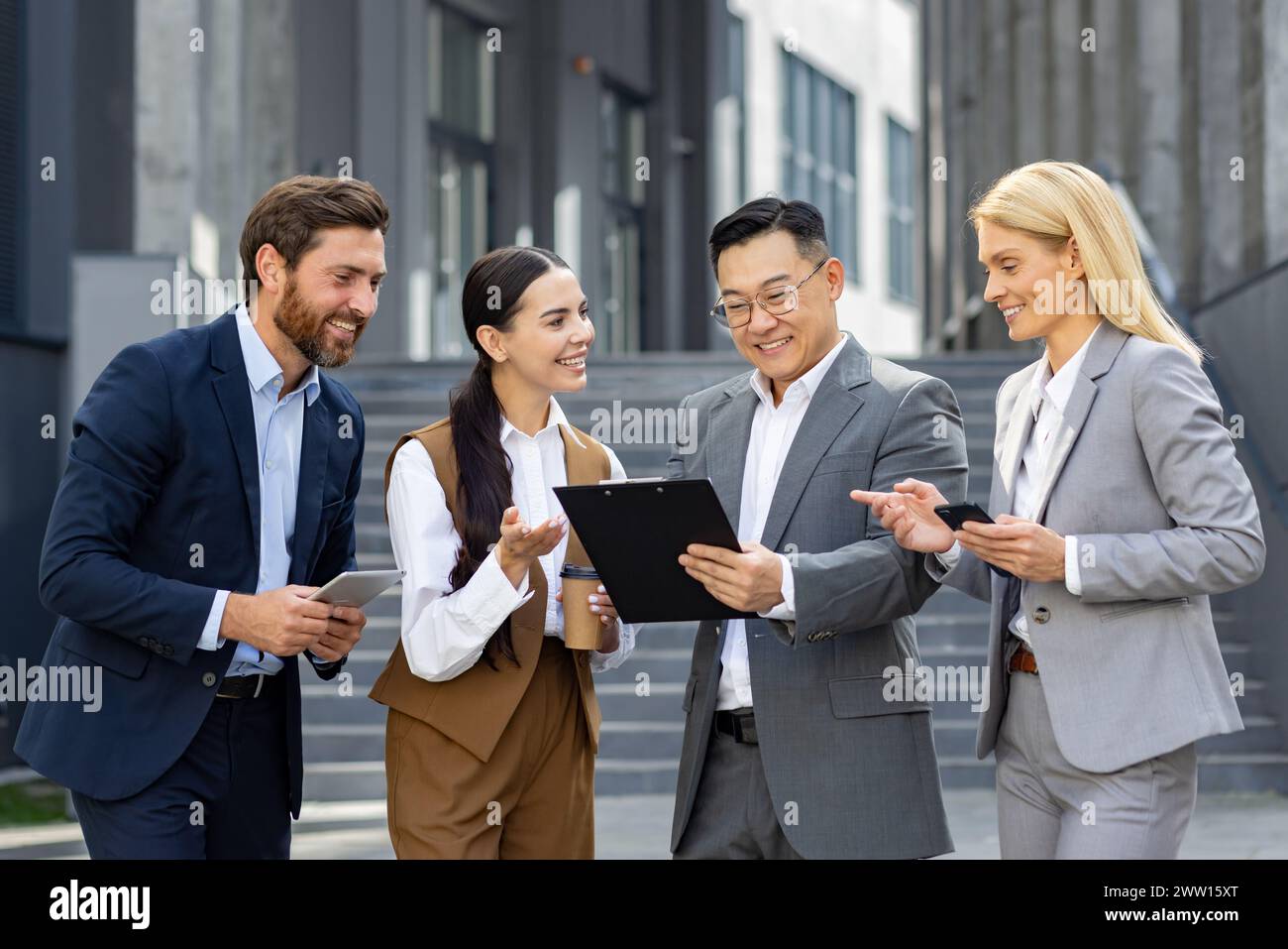 A professional business team in formal attire engaged in a discussion ...