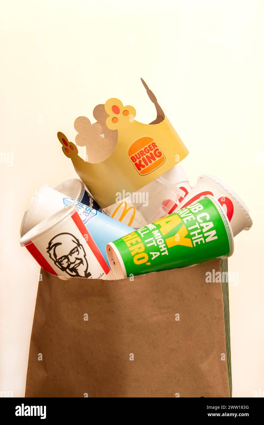 An over flowing trash bag full of fast food drink containers from a ...