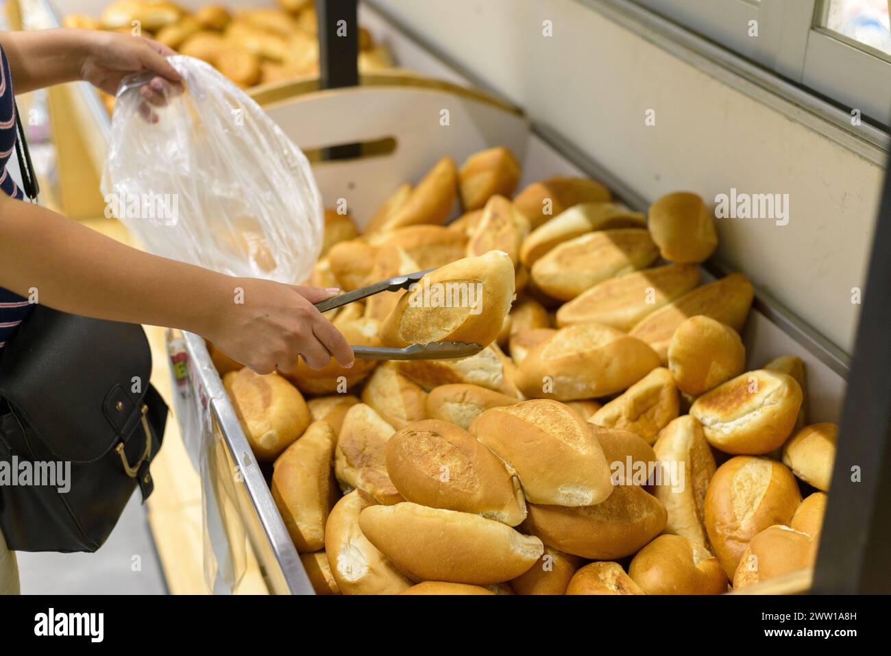 Person selecting breads in a supermarket. Bread stand Stock Photo - Alamy