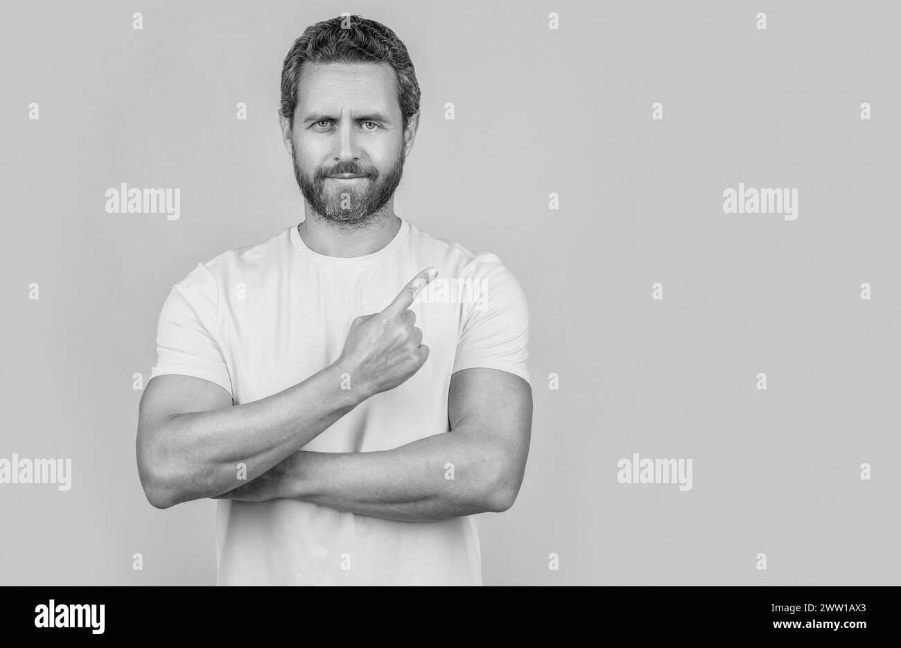 caucasian man pointing at advertisement offer isolated on yellow. man ...