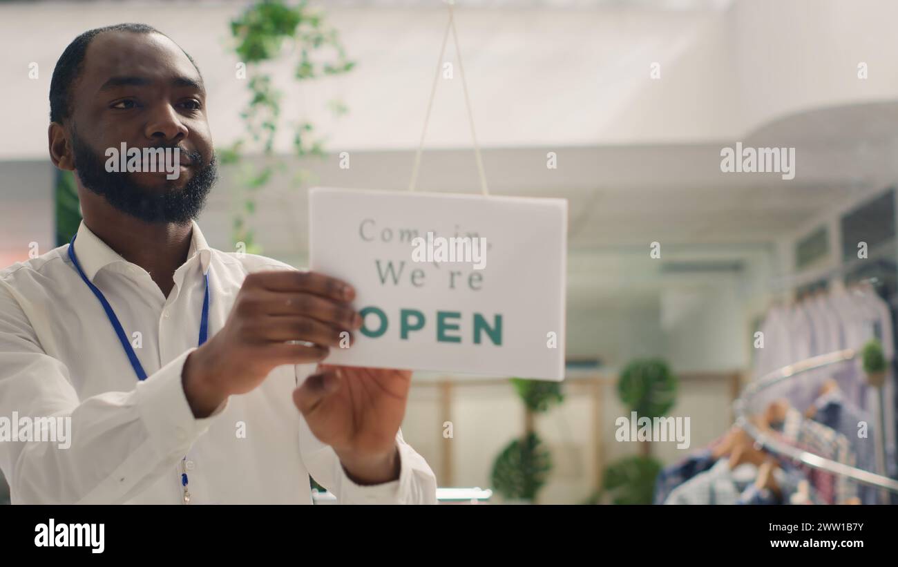 Man turning close sign to open sign hi-res stock photography and images ...