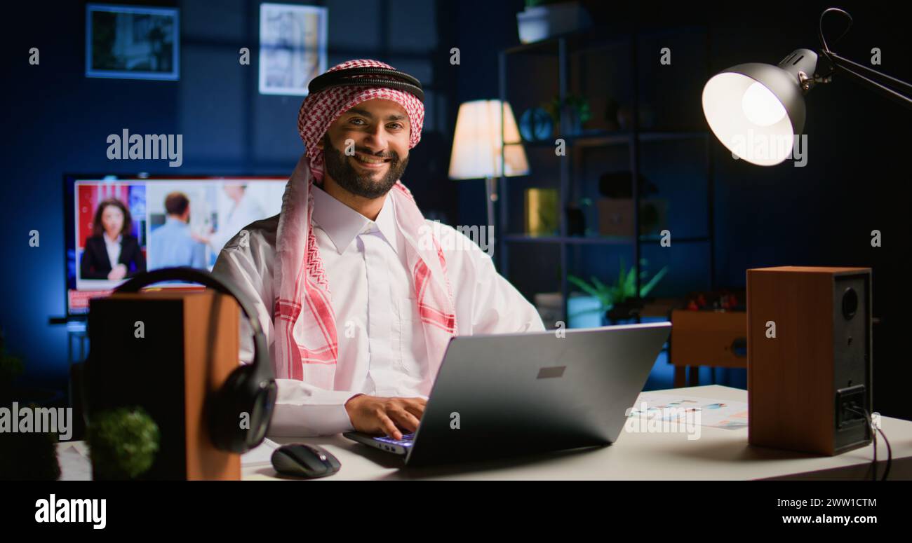 Happy arabic teleworker answering job emails in stylish apartment ...