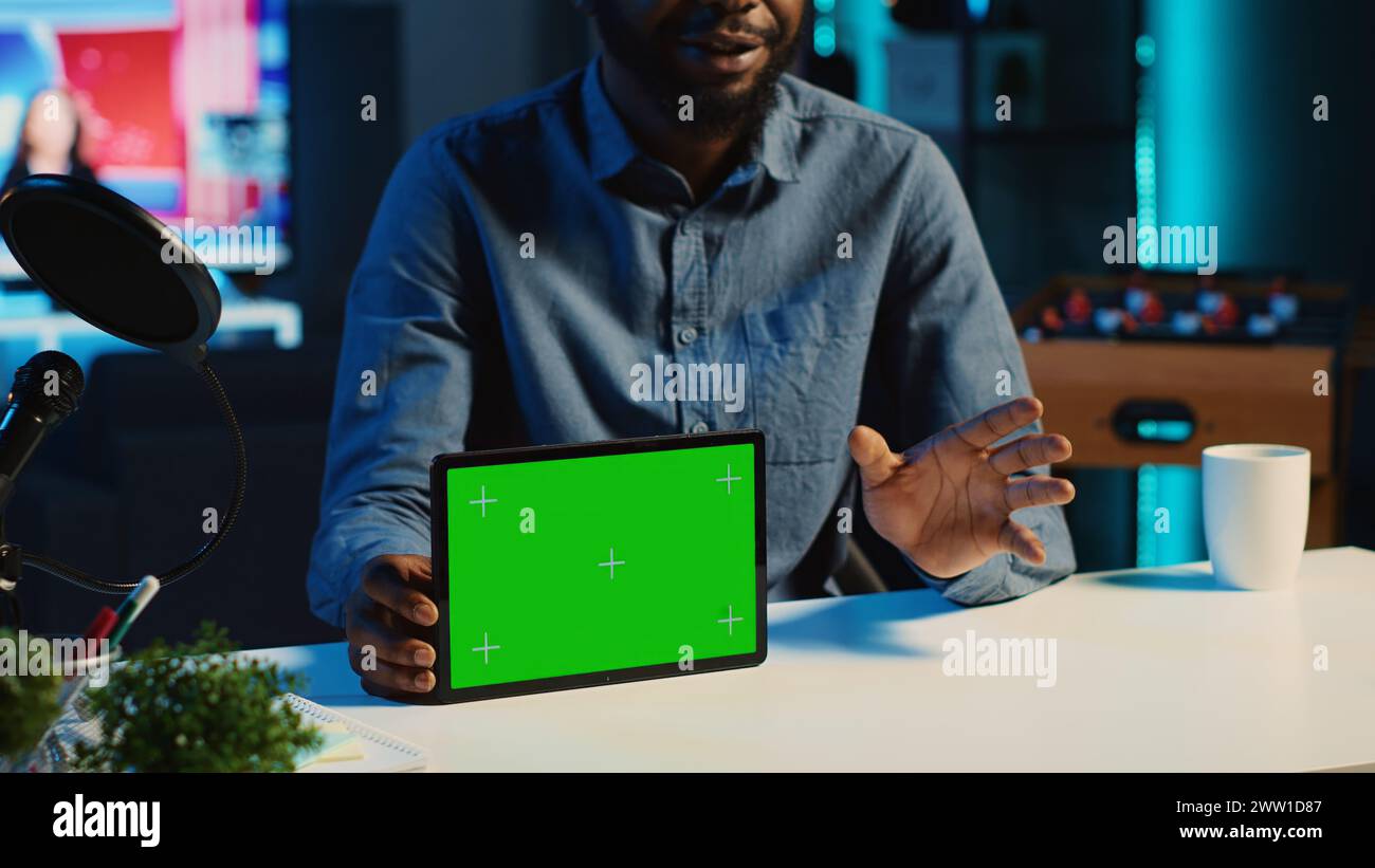 Content creator films chroma key tablet video review for tech enthusiasts using recording ...