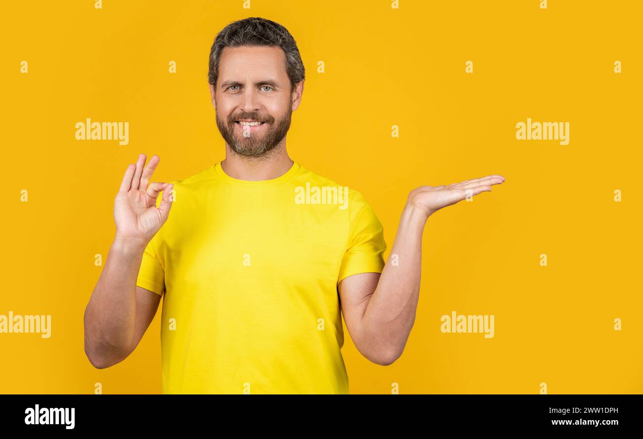 cheerful man presenting advertisement in studio, ok. photo of man ...