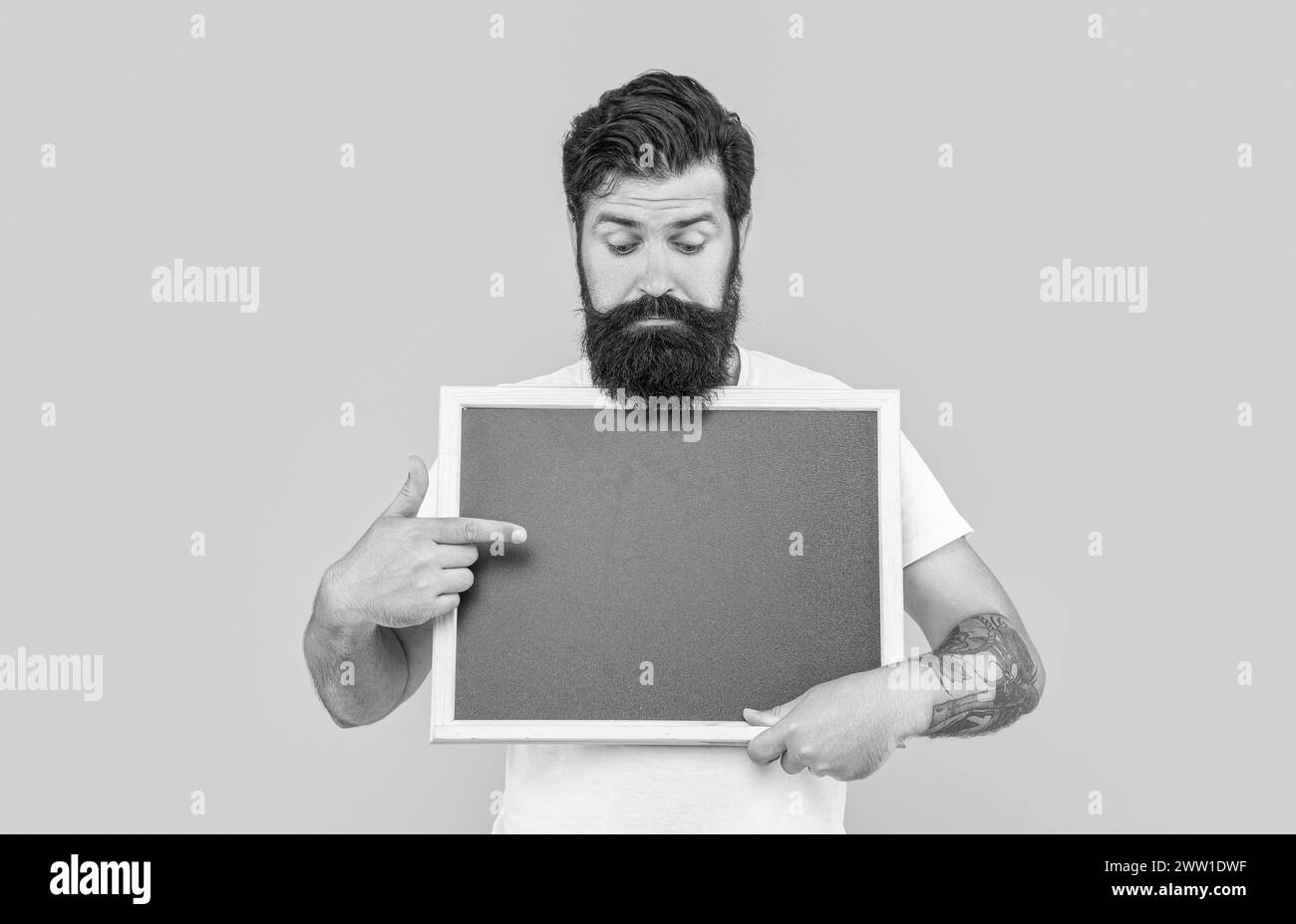 photo of puzzled announcement man with offer on blackboard ...